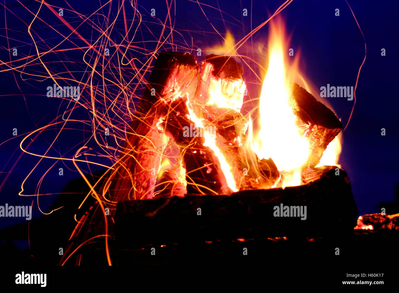 Flame and sparks tracks over dark blue sky photo Stock Photo - Alamy