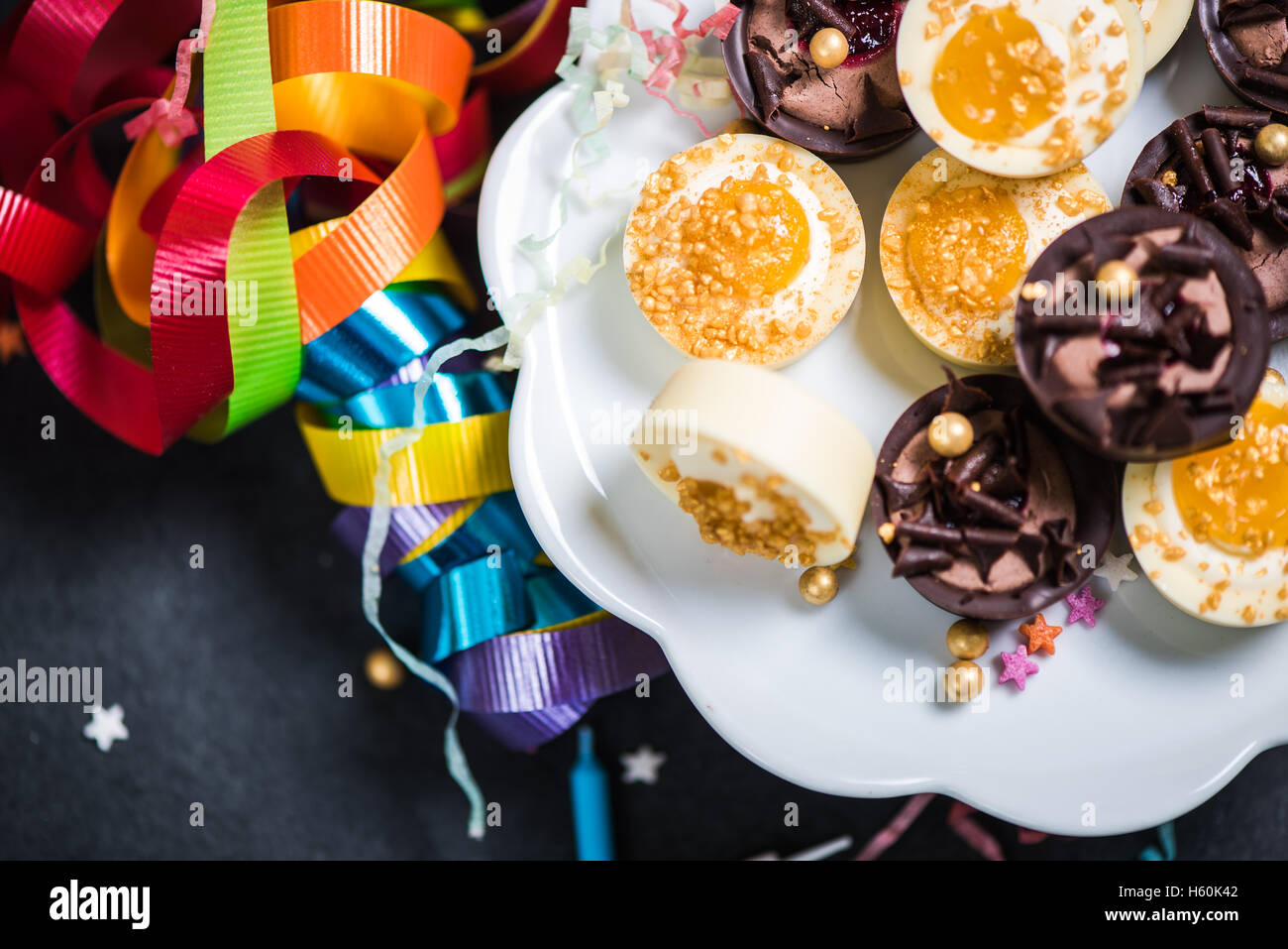 Sweet party food, belgian chocolates decorated by hand Stock Photo - Alamy