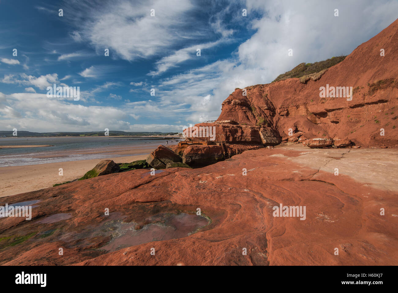 Red cliffs on beach in Exmouth,UK with perfect blue sky Stock Photo - Alamy