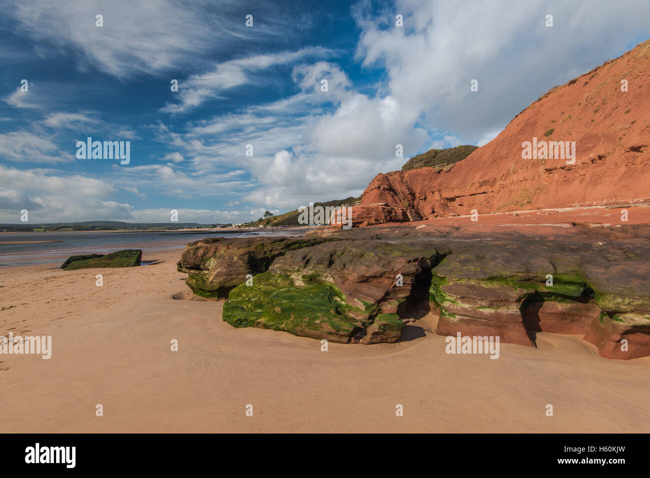 Red cliffs on beach in Exmouth,UK with perfect blue sky Stock Photo - Alamy
