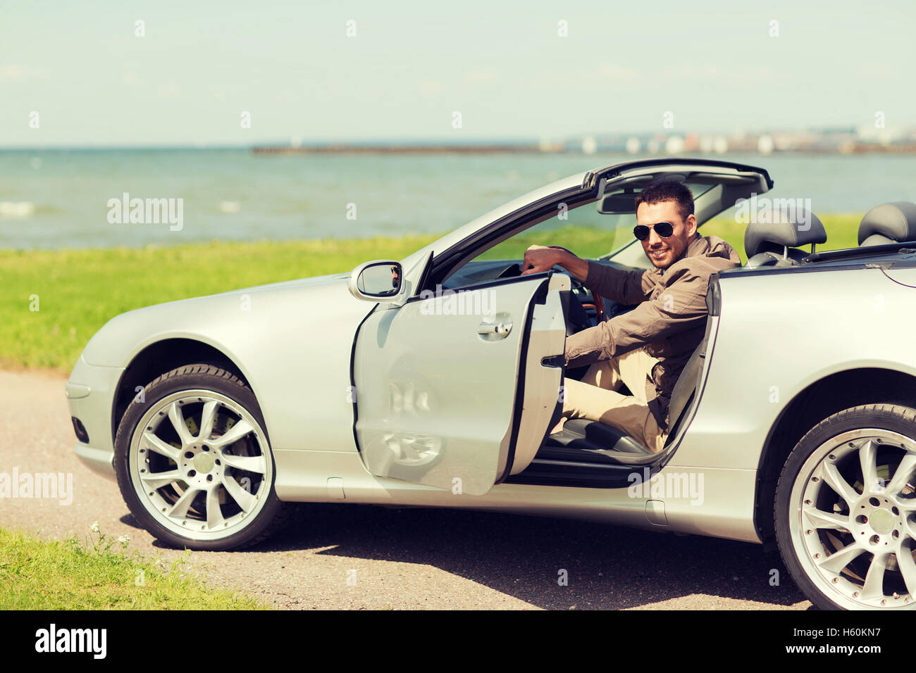 happy man opening door of cabriolet car outdoors Stock Photo - Alamy