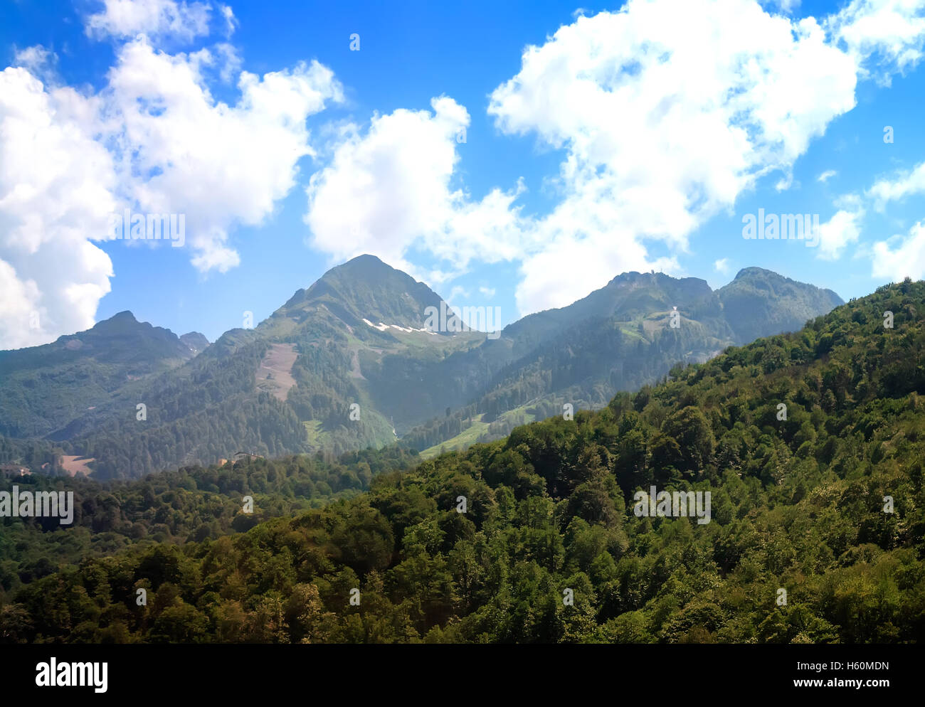 Mountain landscape: steep mountain slopes covered with forests, form a ...