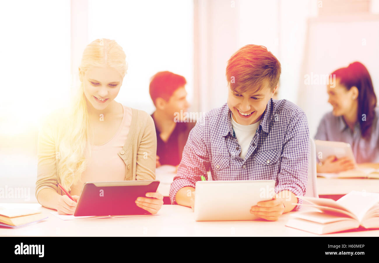 two smiling students with tablet pc at school Stock Photo - Alamy