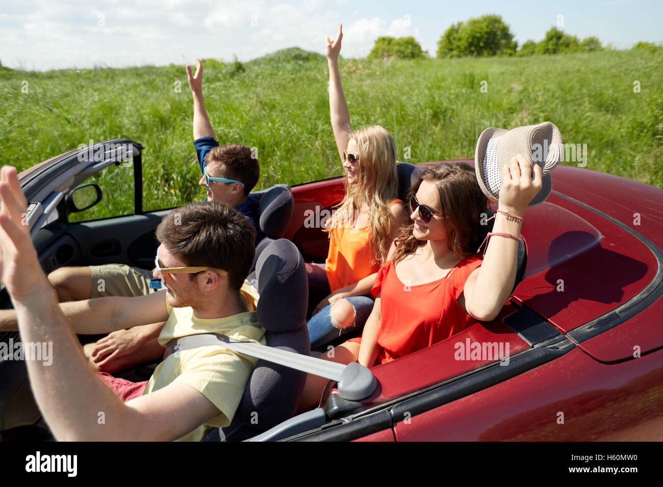 happy friends driving in cabriolet car at country Stock Photo - Alamy