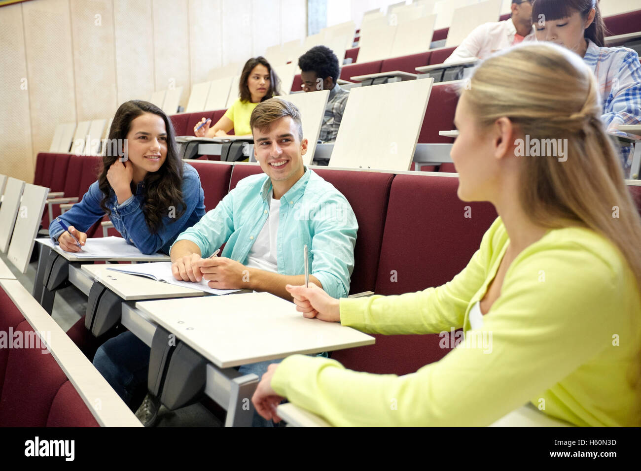 group of students with notebooks at lecture hall Stock Photo - Alamy