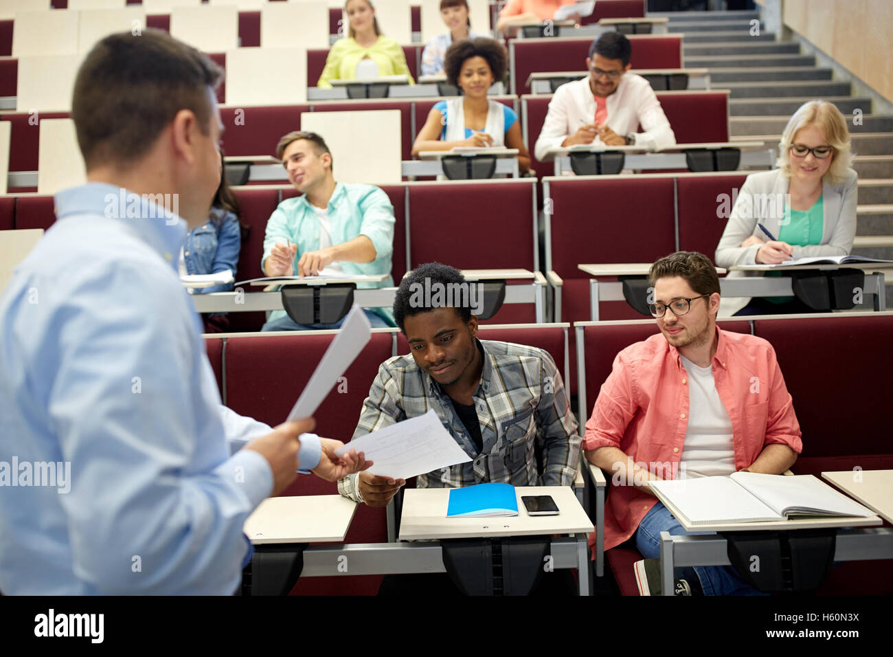 teacher giving tests to students at lecture Stock Photo - Alamy