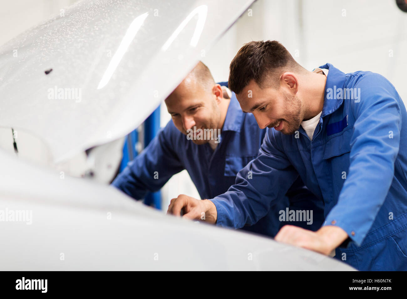 mechanic men with wrench repairing car at workshop Stock Photo - Alamy