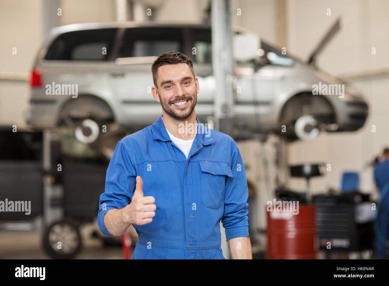 happy auto mechanic man or smith at car workshop Stock Photo - Alamy