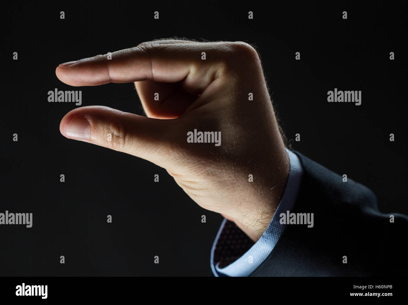 close up of businessman hand showing small size Stock Photo - Alamy