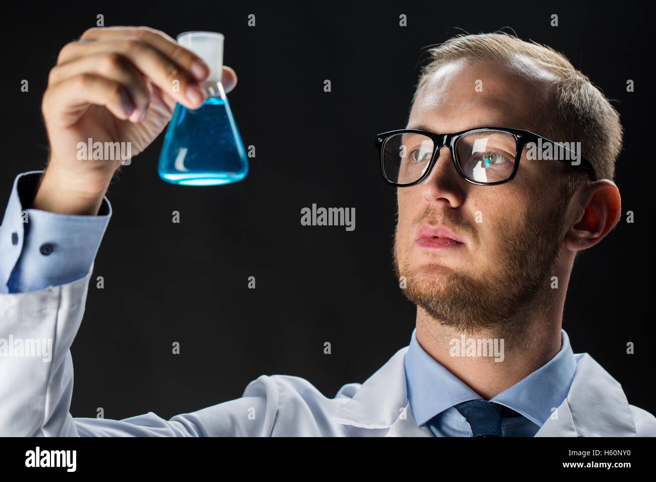 young scientist holding test flask with chemical Stock Photo - Alamy