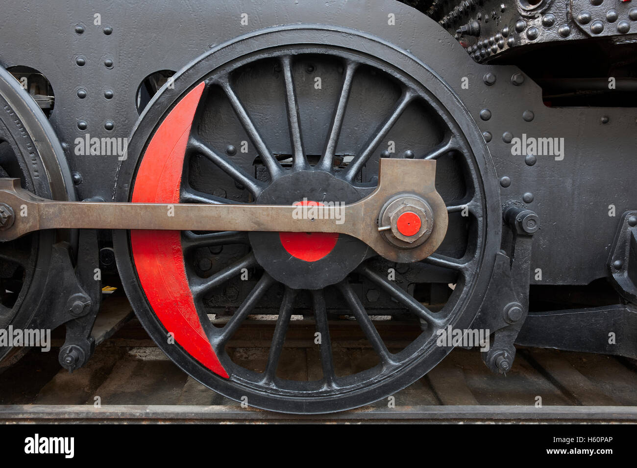 Steam locomotive wheel and connecting rod detail. Black and red ...
