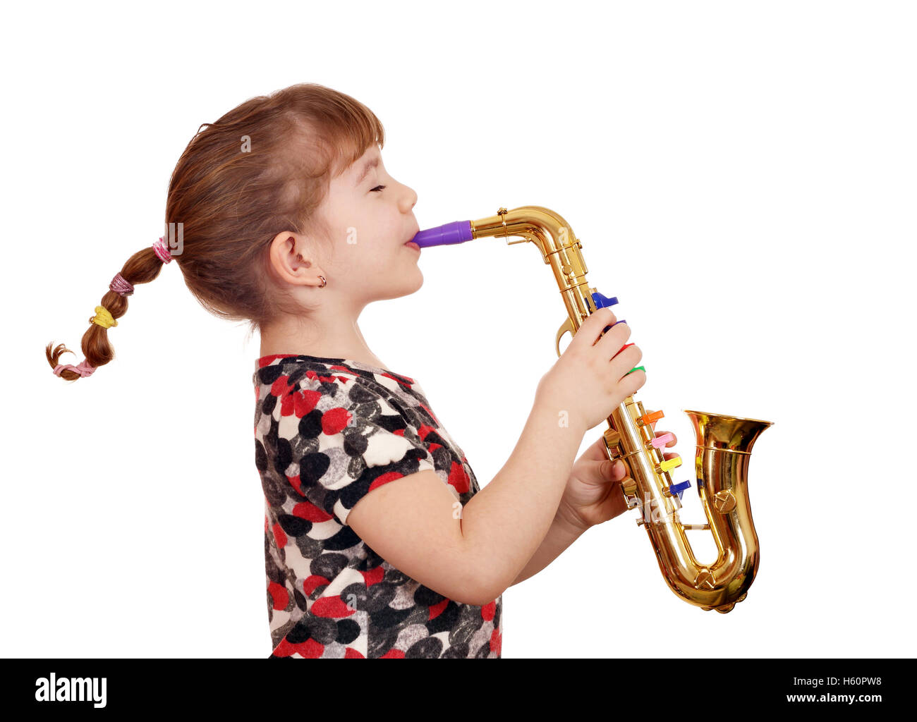beautiful little girl play music on saxophone Stock Photo - Alamy