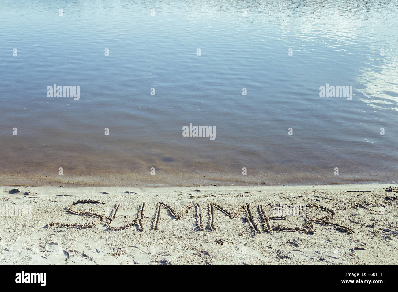 Sand on beach and river water Stock Photo - Alamy