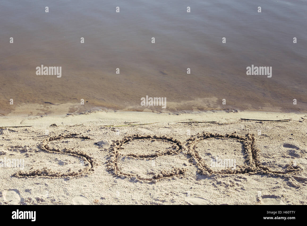 Sand on beach and river water Stock Photo - Alamy