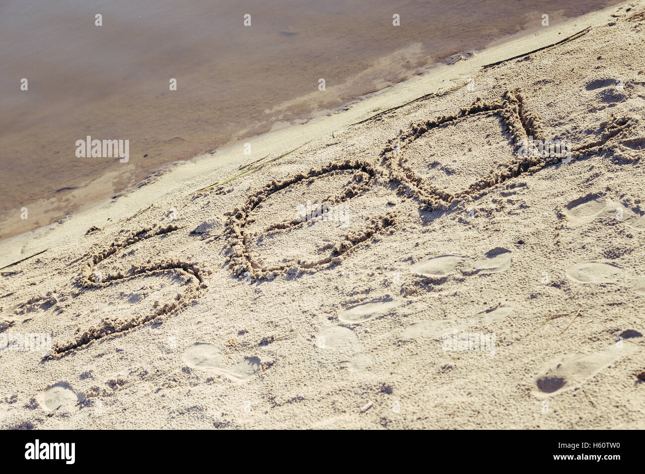 Sand on beach and river water Stock Photo - Alamy