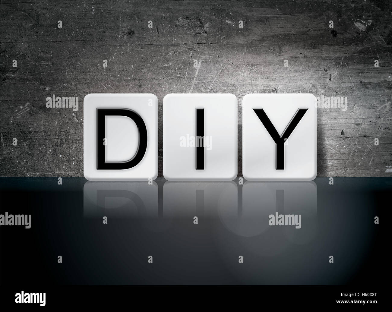 The word "DIY" written in white tiles against a dark vintage grunge ...