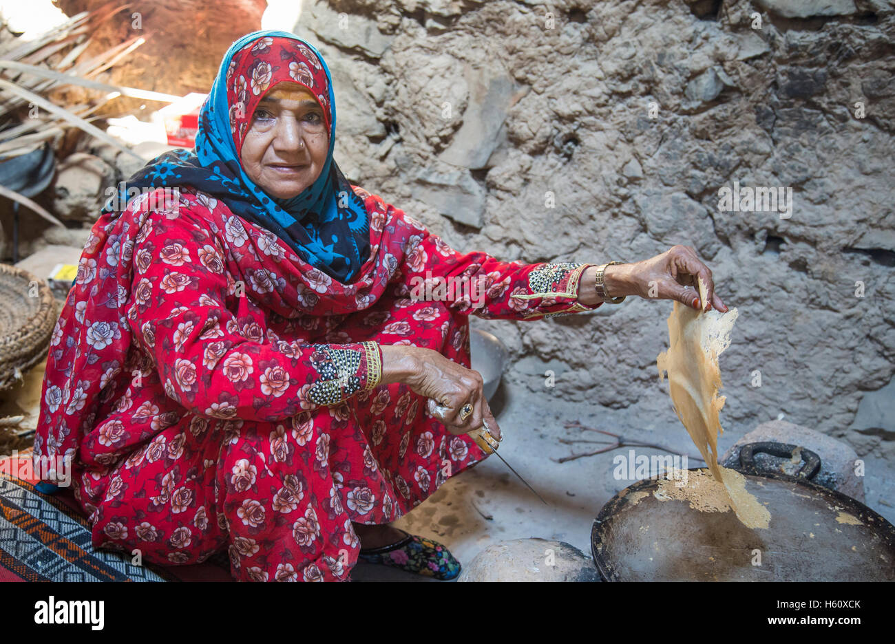 Nizwa, Oman, October 13th, 2016: omani lady making bread Stock Photo ...