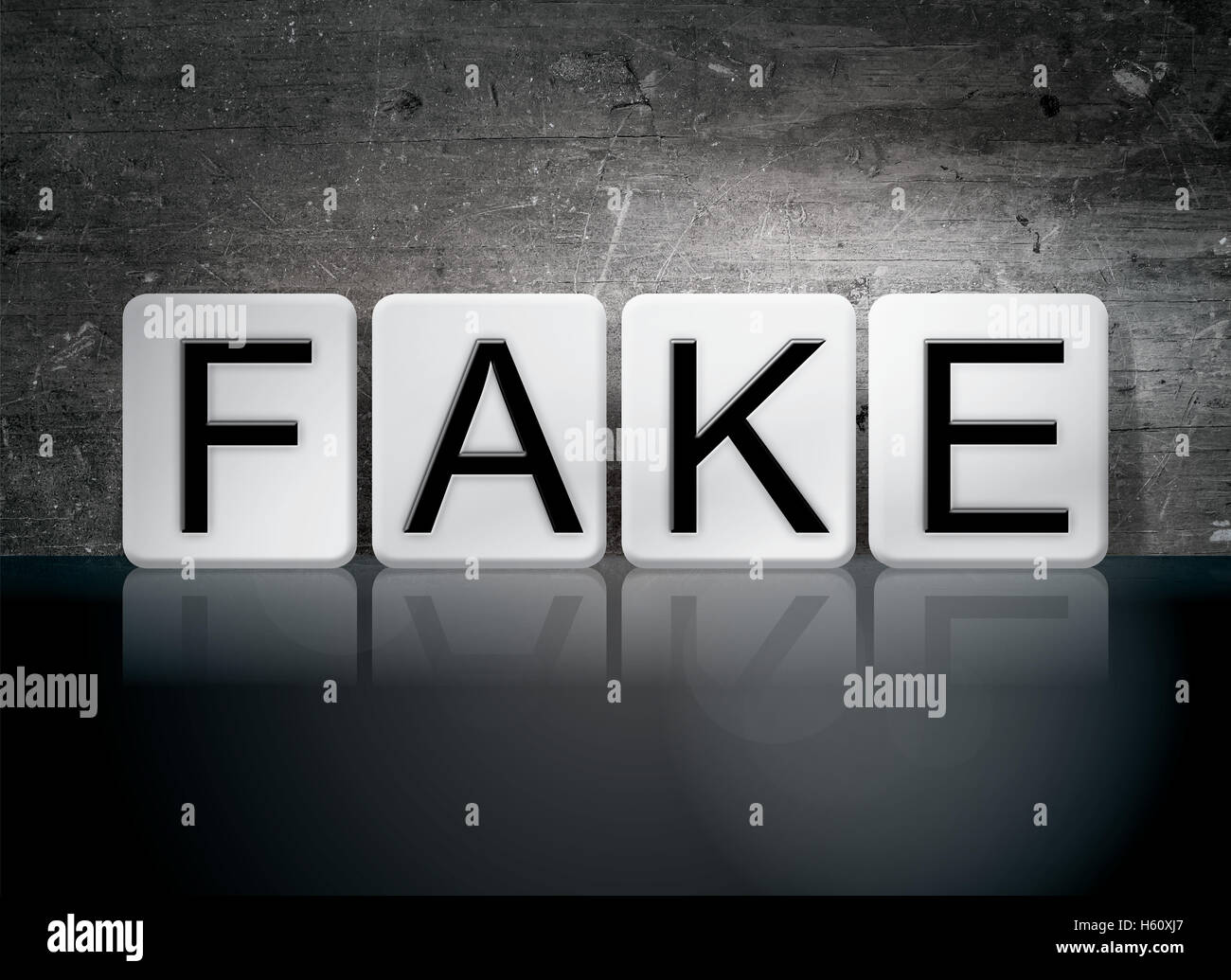 The word "Fake" written in white tiles against a dark vintage grunge ...