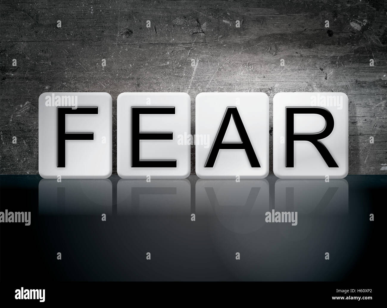 The word "Fear" written in white tiles against a dark vintage grunge ...