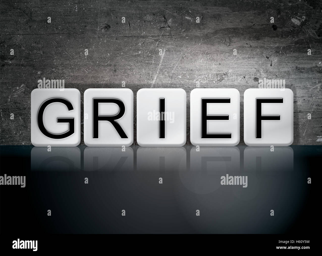 The word "Grief" written in white tiles against a dark vintage grunge ...