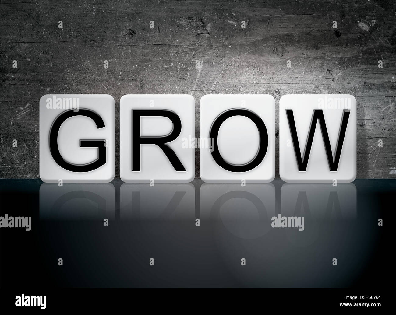 The word "Grow" written in white tiles against a dark vintage grunge ...