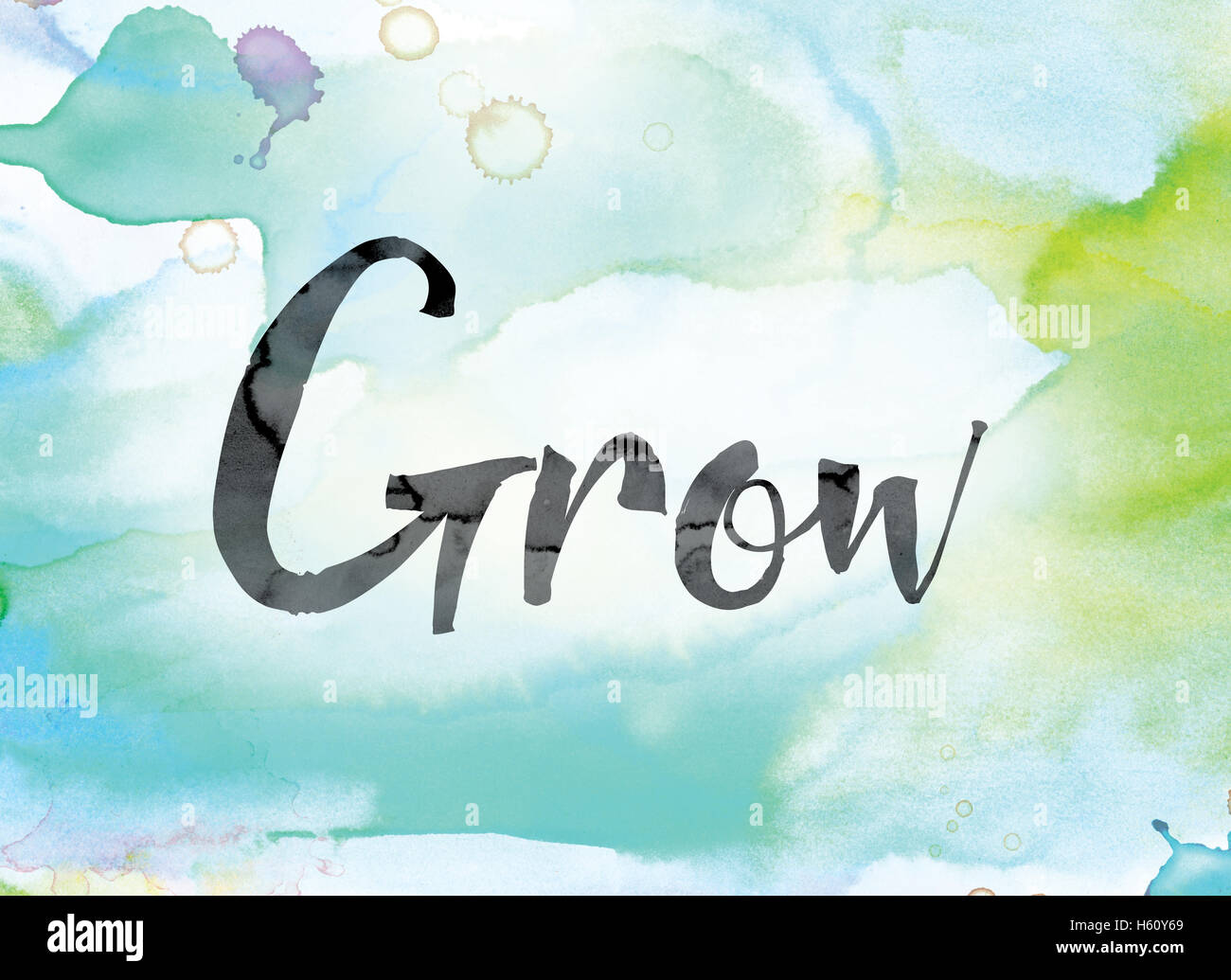 The word "Grow" painted in black ink over a colorful watercolor washed ...