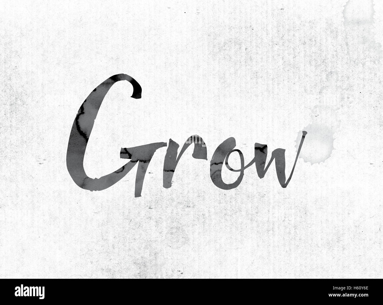 The word "Grow" concept and theme painted in watercolor ink on a white ...