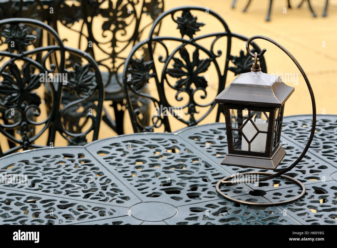 chairs and table with old lantern, outdoor restaurant Stock Photo - Alamy
