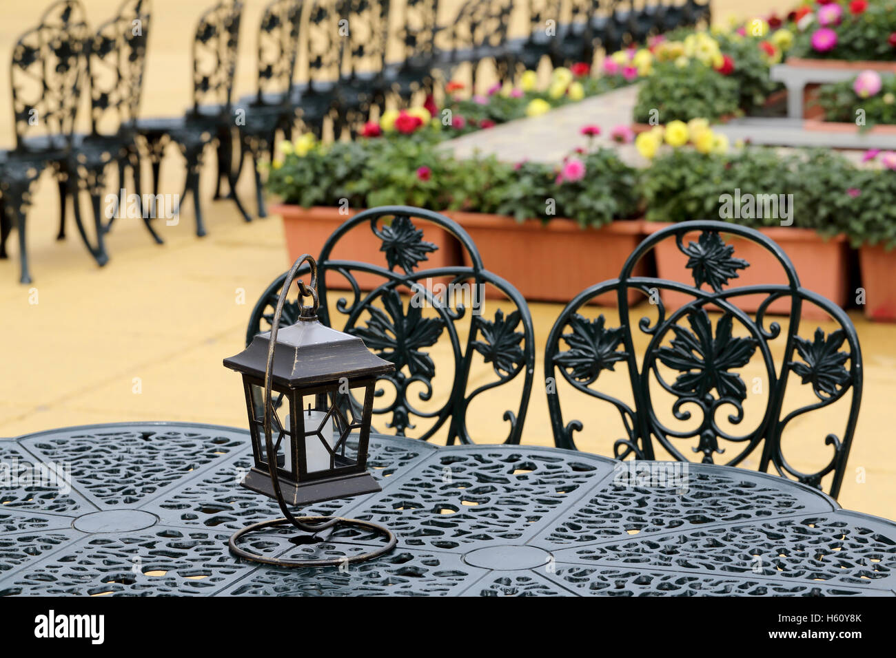 chairs and table with old lantern, outdoor restaurant Stock Photo - Alamy