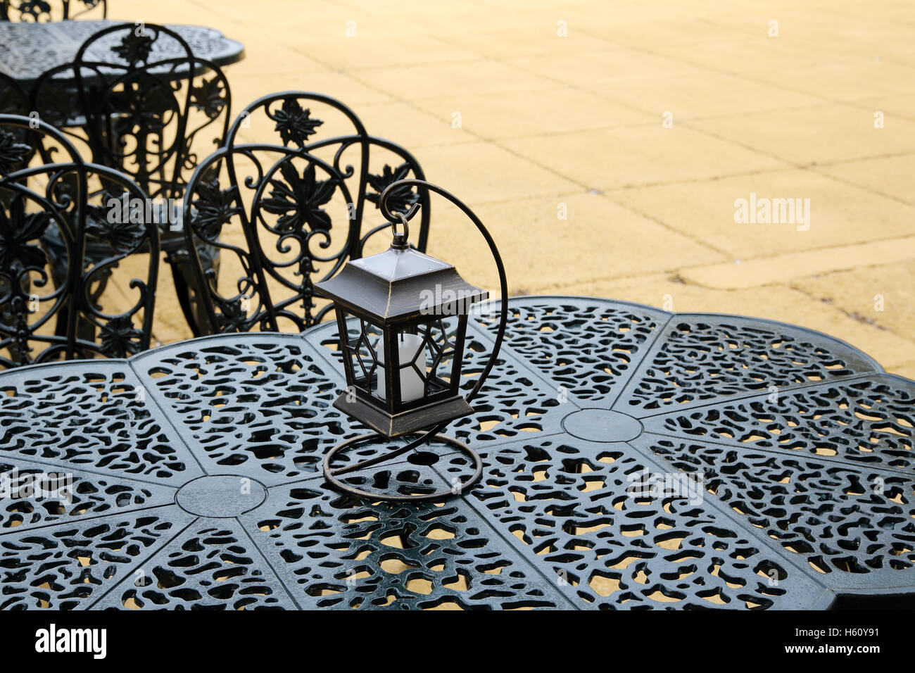 chairs and table with old lantern, outdoor restaurant Stock Photo - Alamy