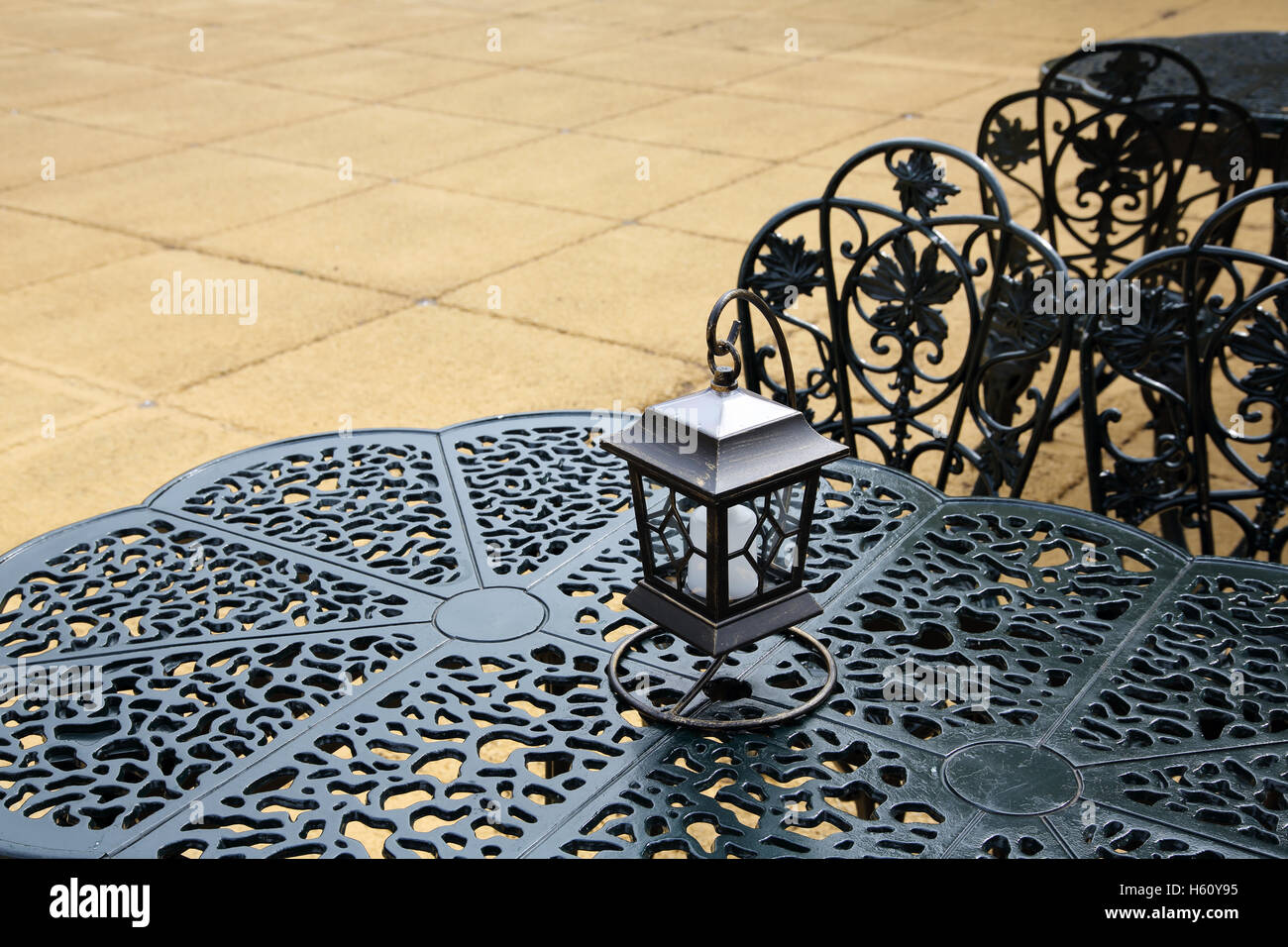 chairs and tables with old lantern, outdoor restaurant Stock Photo - Alamy