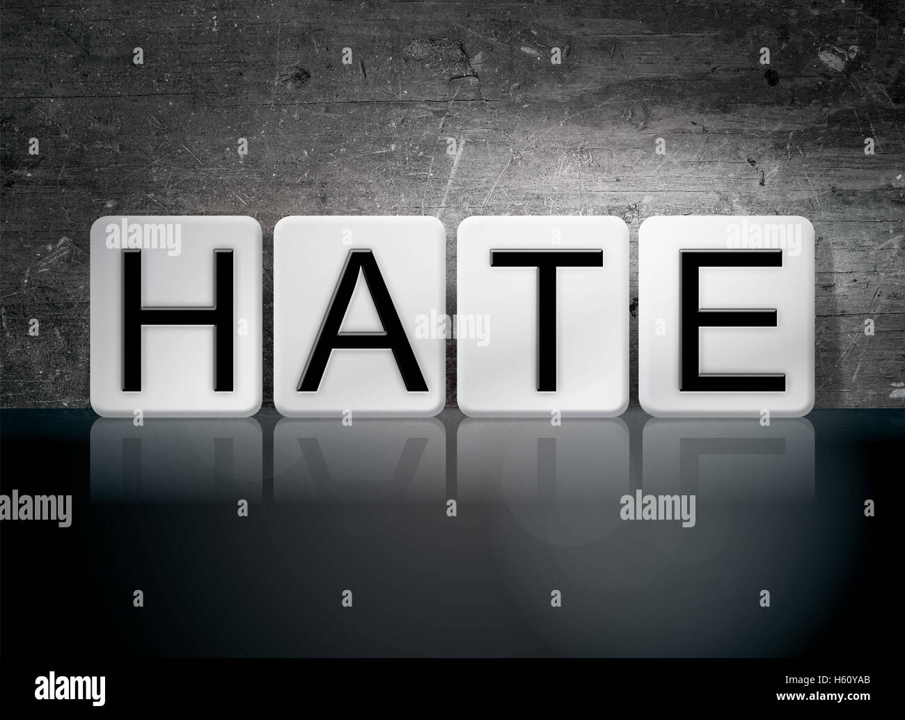 The word "Hate" written in white tiles against a dark vintage grunge ...