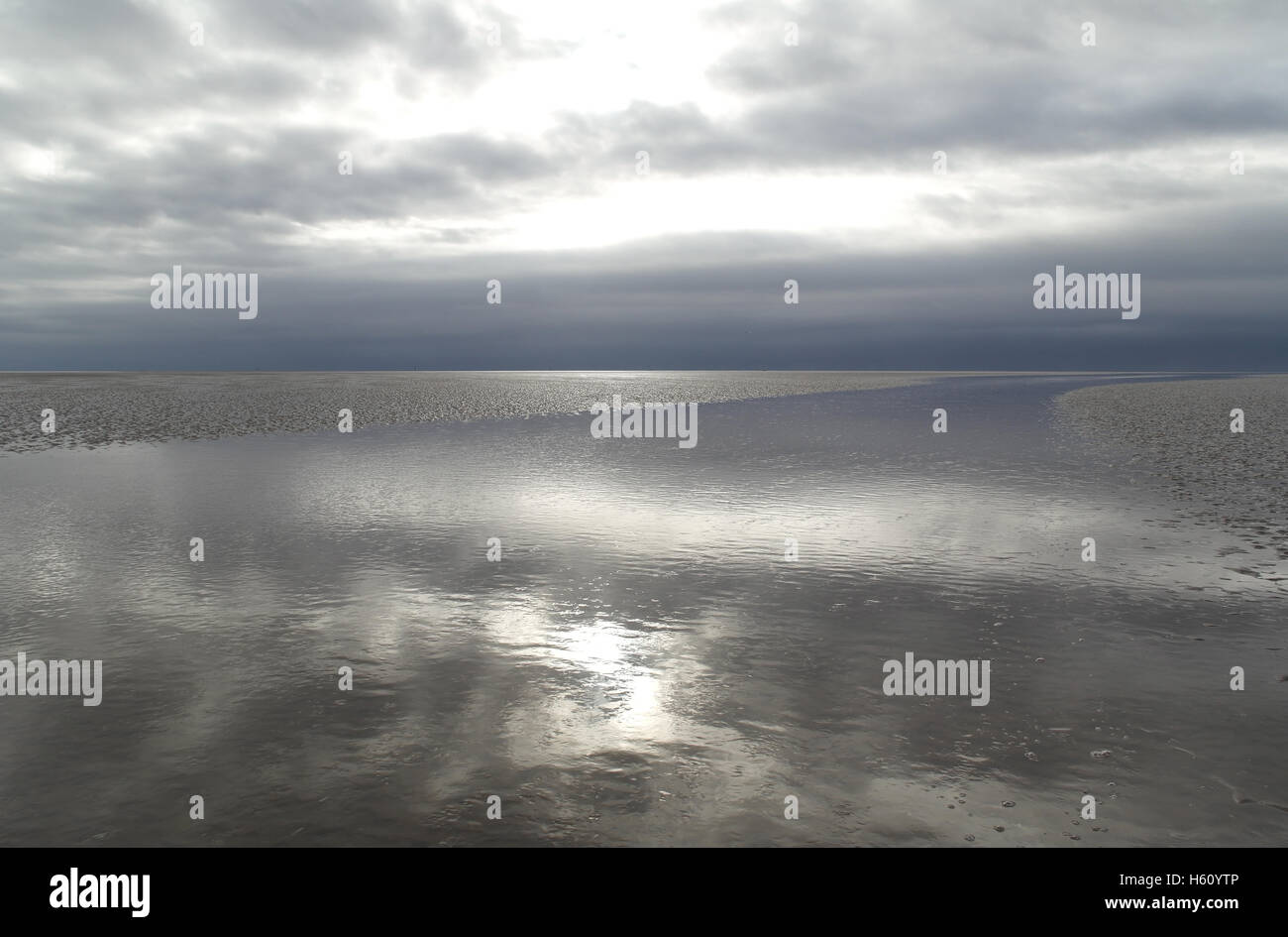 Wide shallow sea water channel foreground extending narrowing centre ...