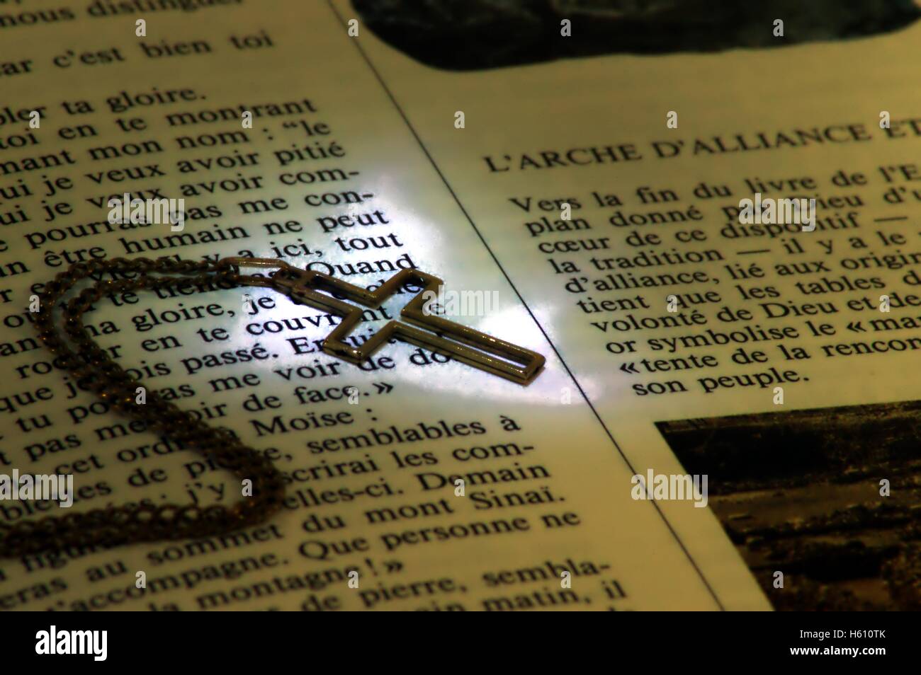 Catholic cross pendant put on a book Stock Photo - Alamy
