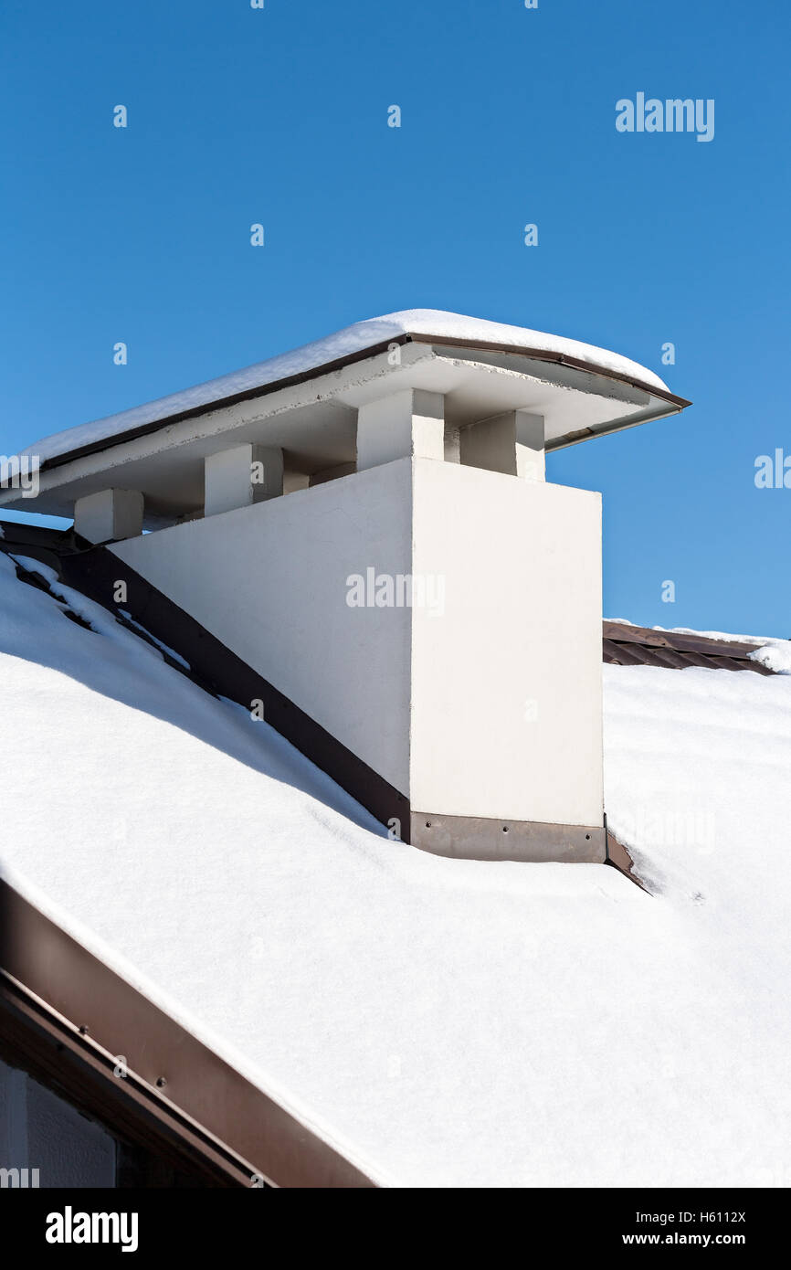 Chimney on roof covered with snow against blue sky Stock Photo - Alamy