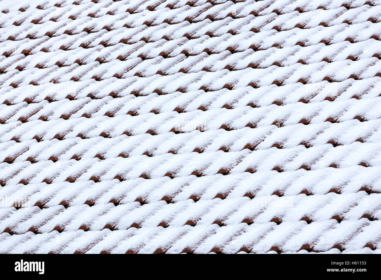 tiled roof covered with snow background texture Stock Photo - Alamy