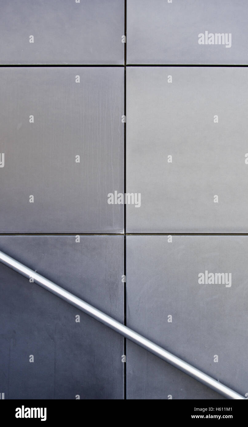 Railing against the wall, detail of a railing on a wall of tiles ...
