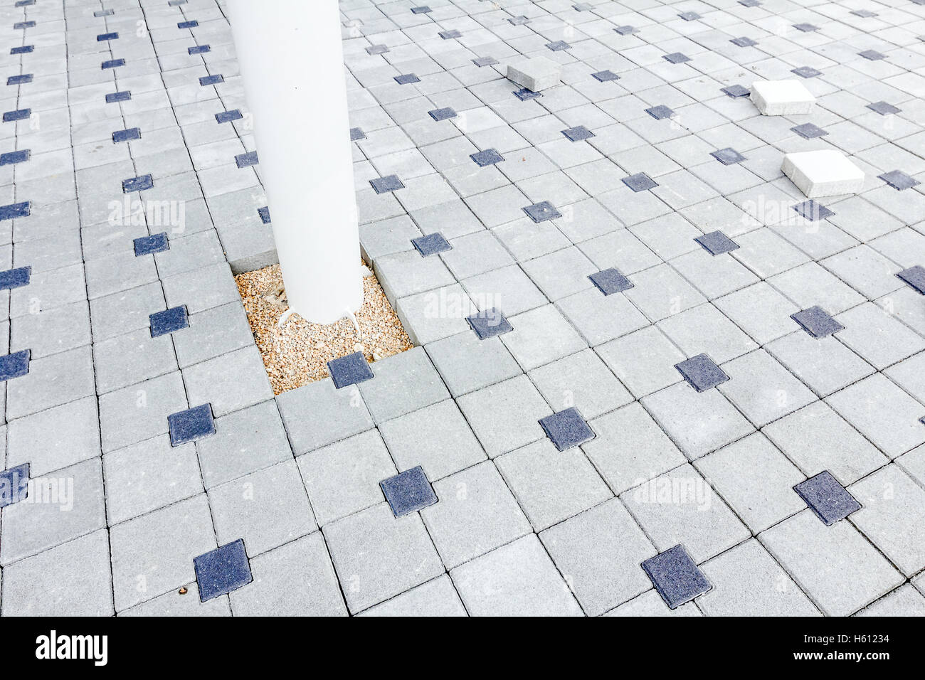 White steel pillar is carrier of construction; ground is covered with ...