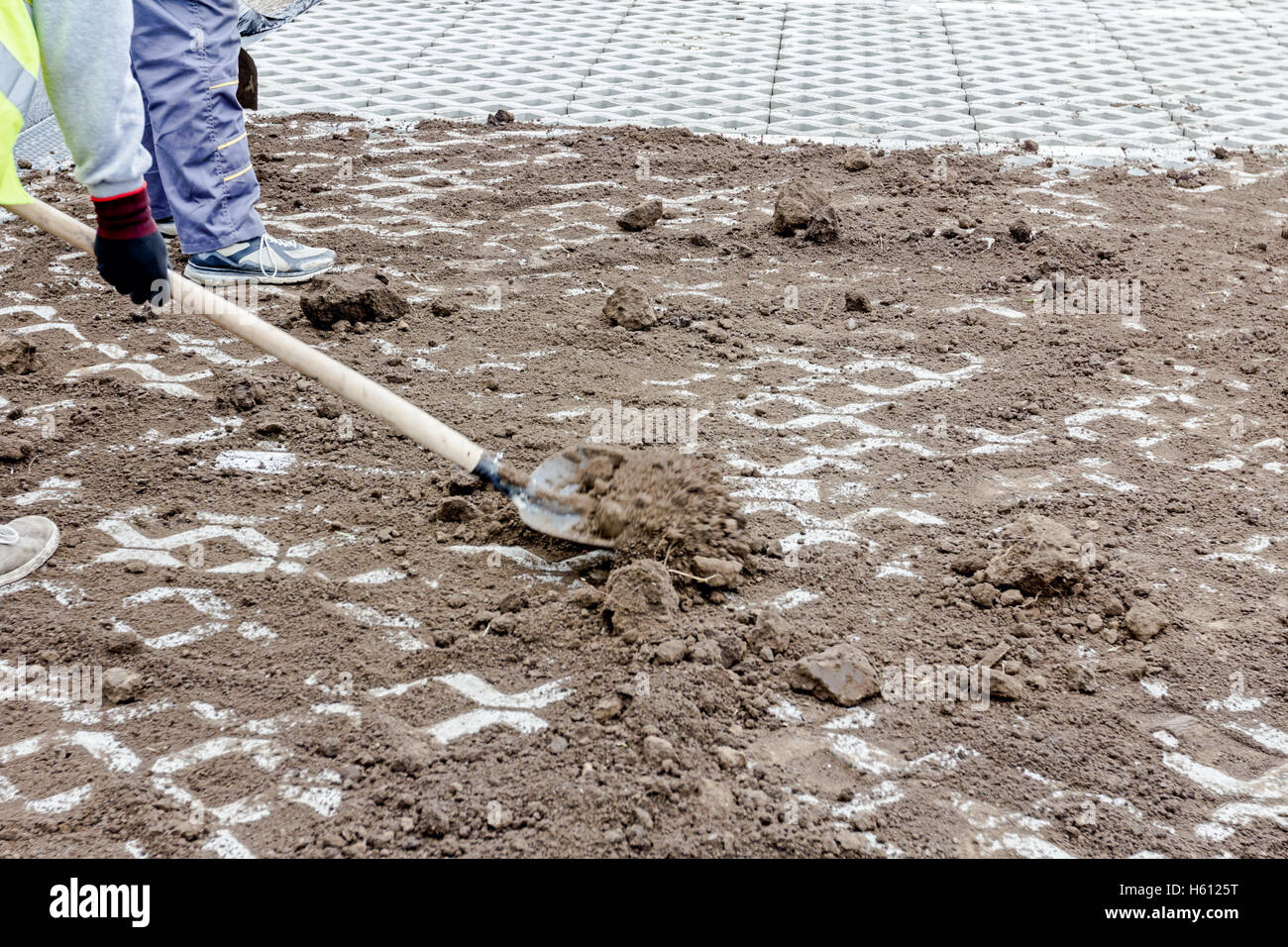 Workers are filling out symmetrical and decorative precast cobblestone ...