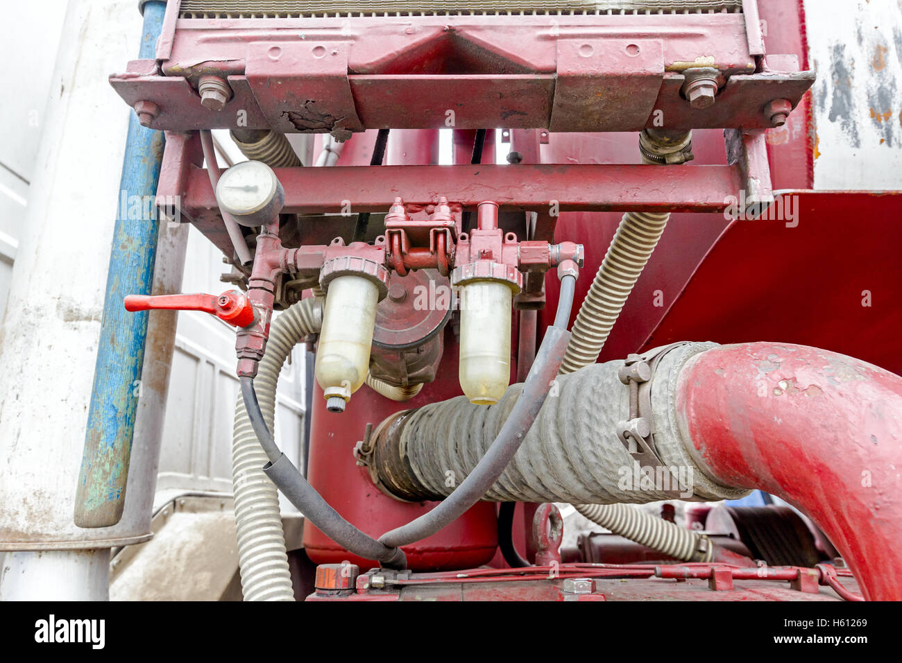 View on truck compressor, water hose with couplings piled on the sewage ...