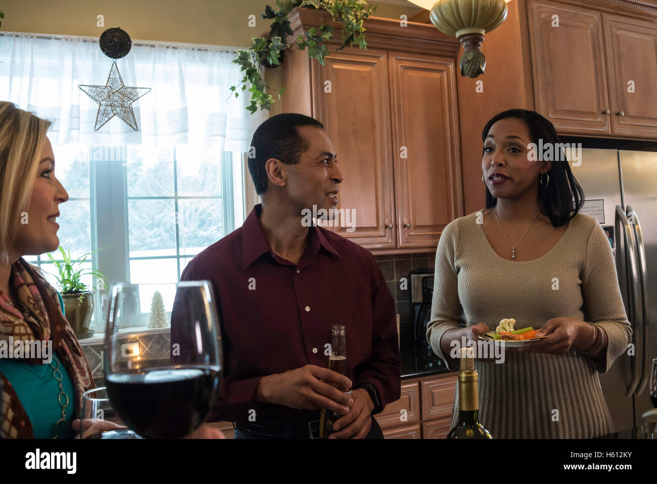 Group of multi ethnic people in home kitchen party scene Stock Photo ...