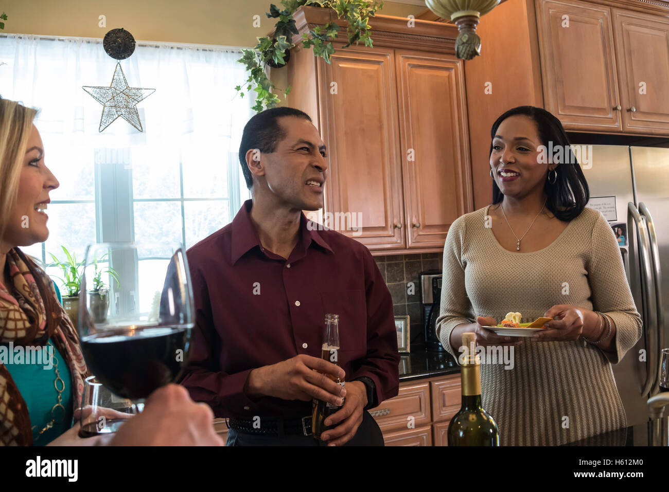 Group of multi ethnic people in home kitchen party scene Stock Photo ...