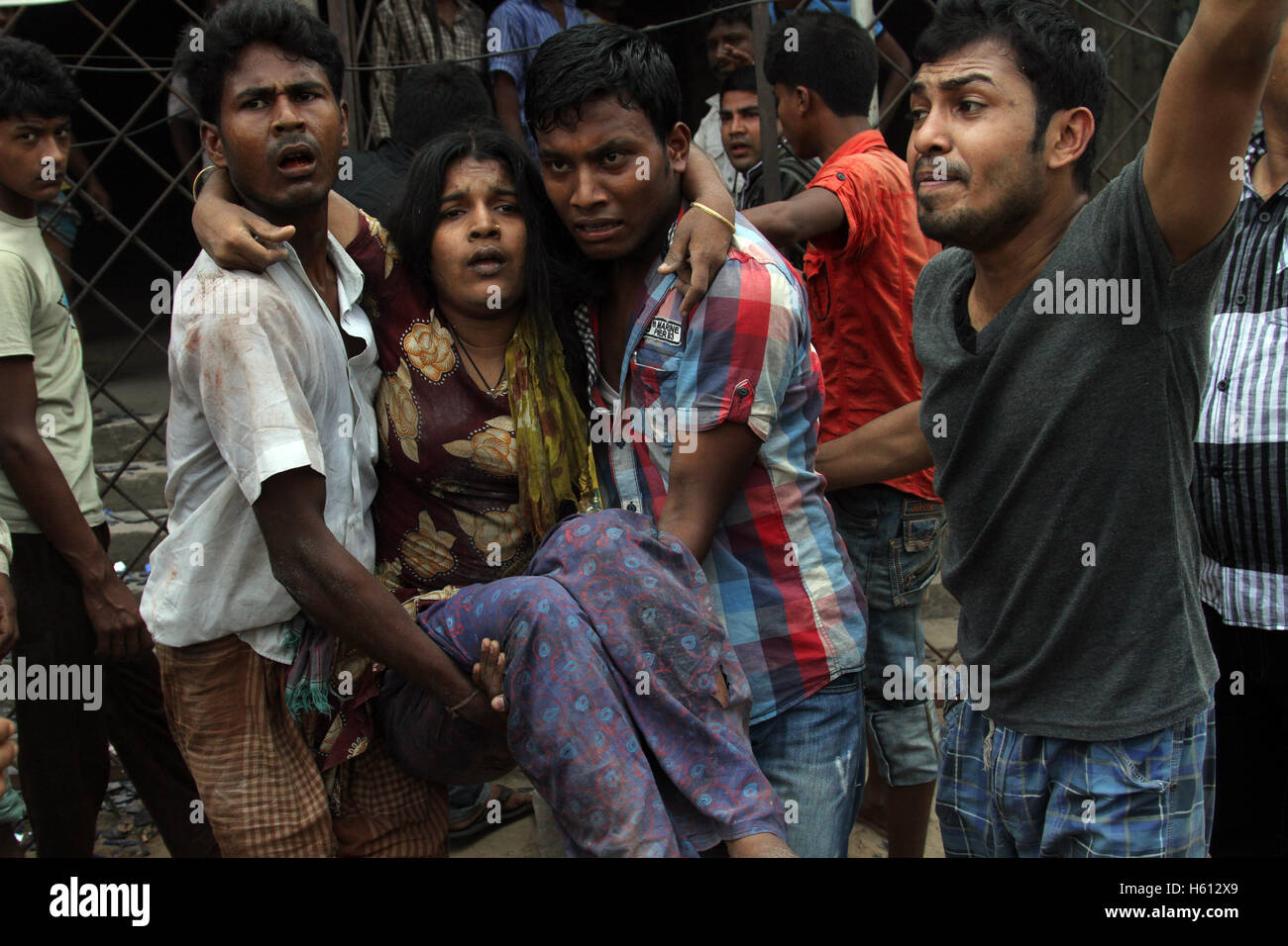 People rescue garment worker who was trapped under the rubble of the ...