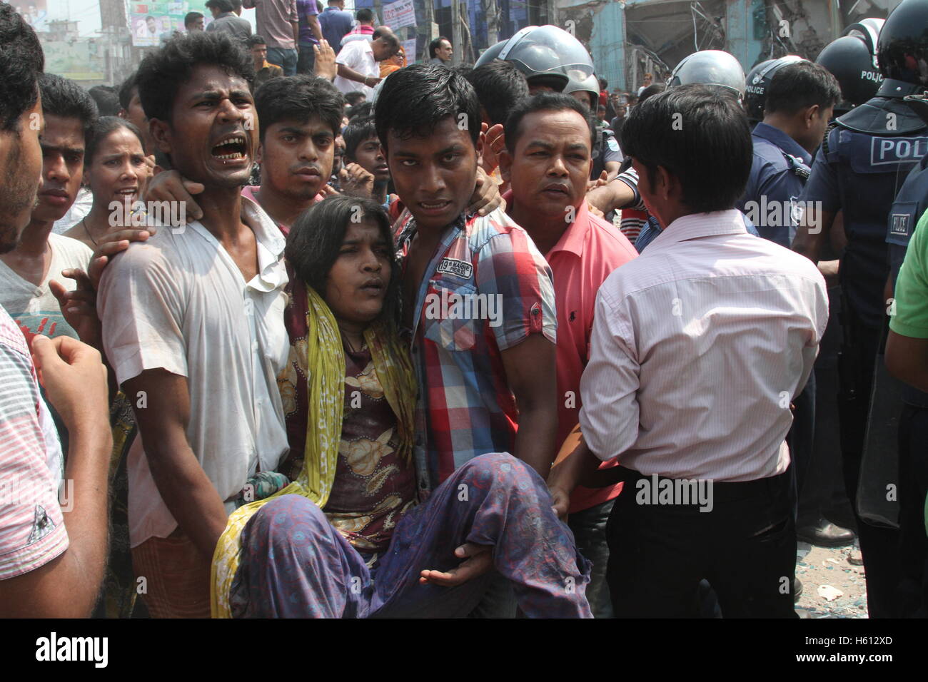 People rescue garment worker who was trapped under the rubble of the ...