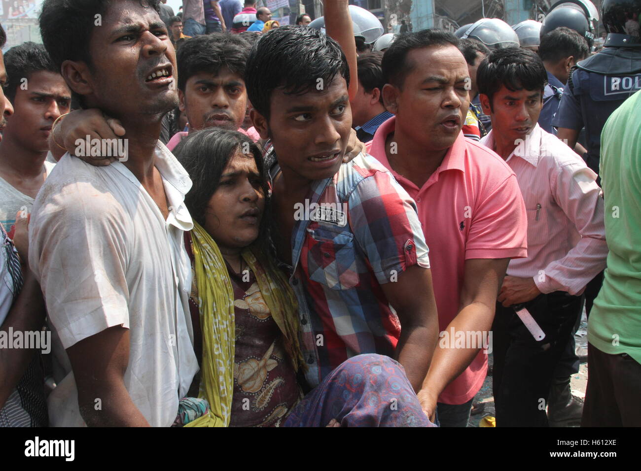 People rescue garment worker who was trapped under the rubble of the ...
