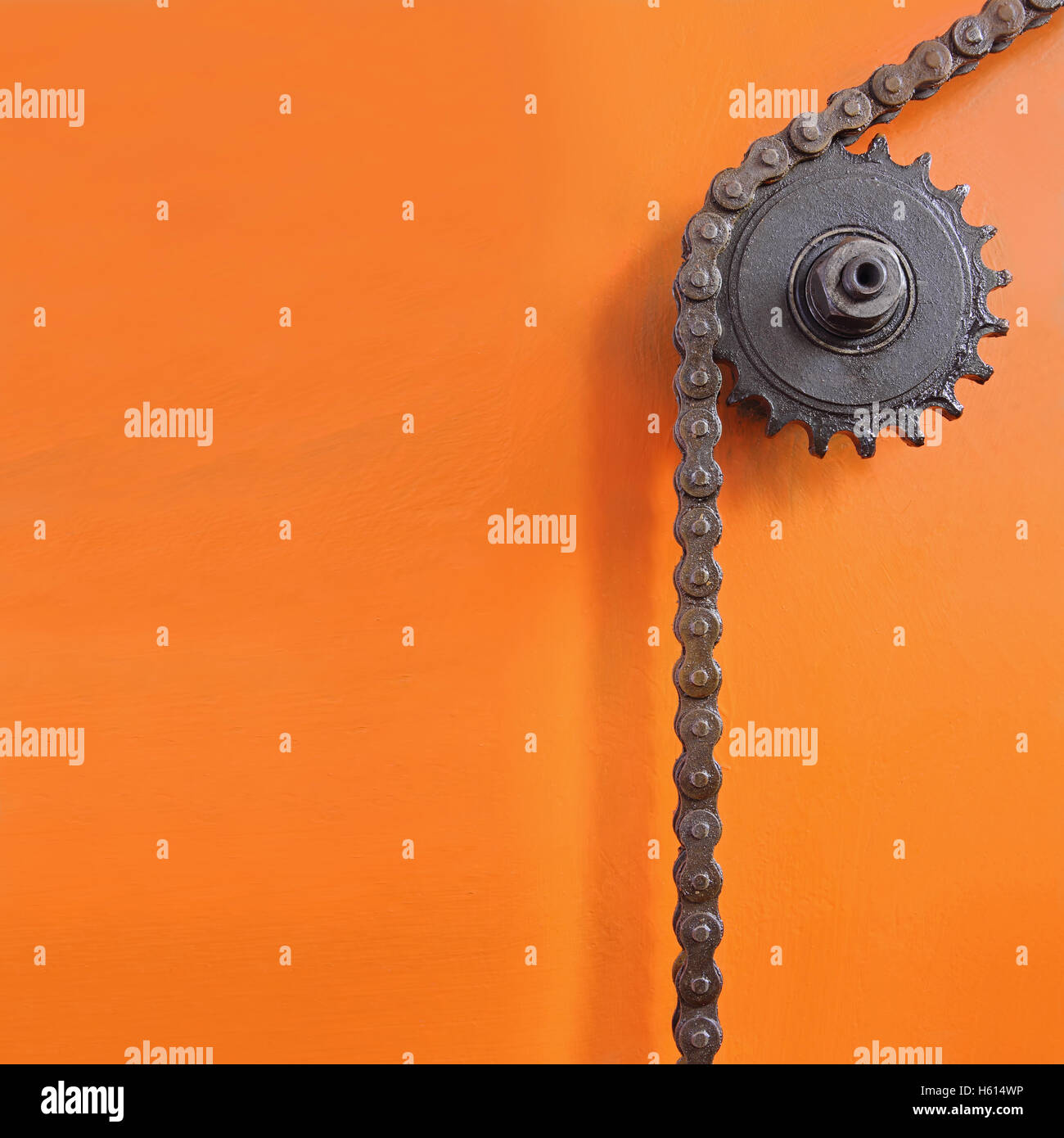 Metal cogwheel and chain on orange background with empty space Stock ...