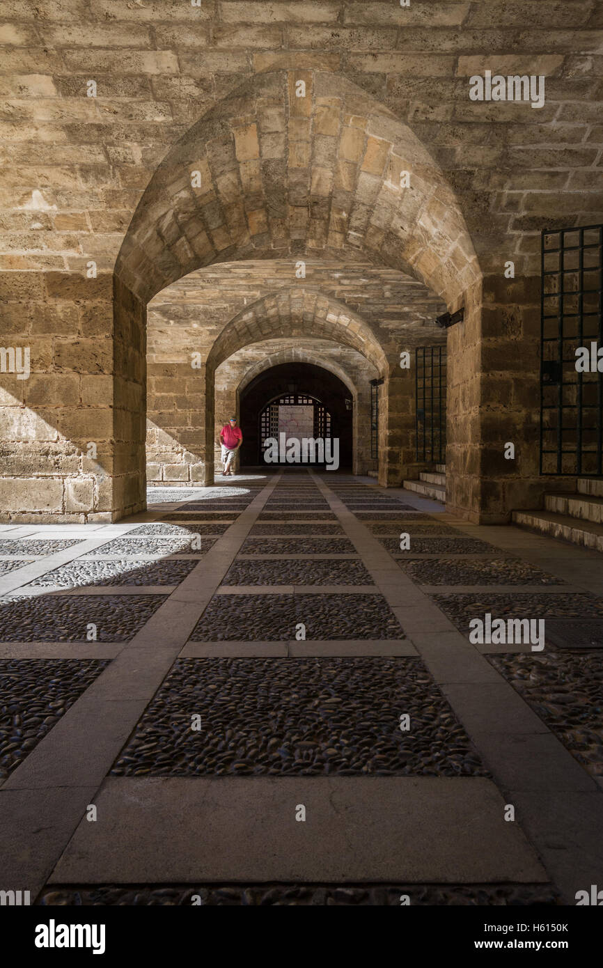 man casually leaning on wall in vault arches with stone walls Stock ...