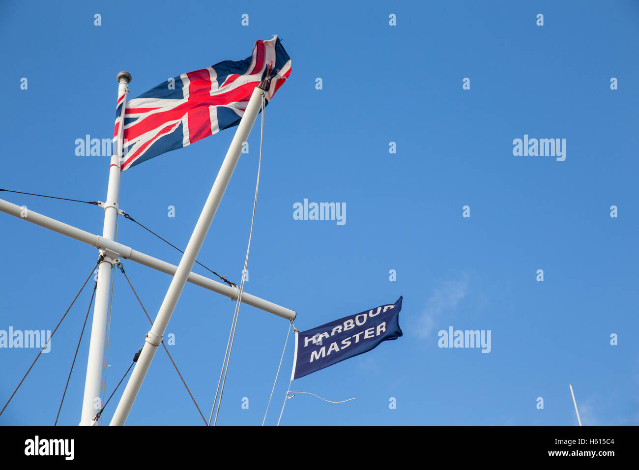 Harbour Master's flag and the Union Flag flying at Lyme Regis Stock ...