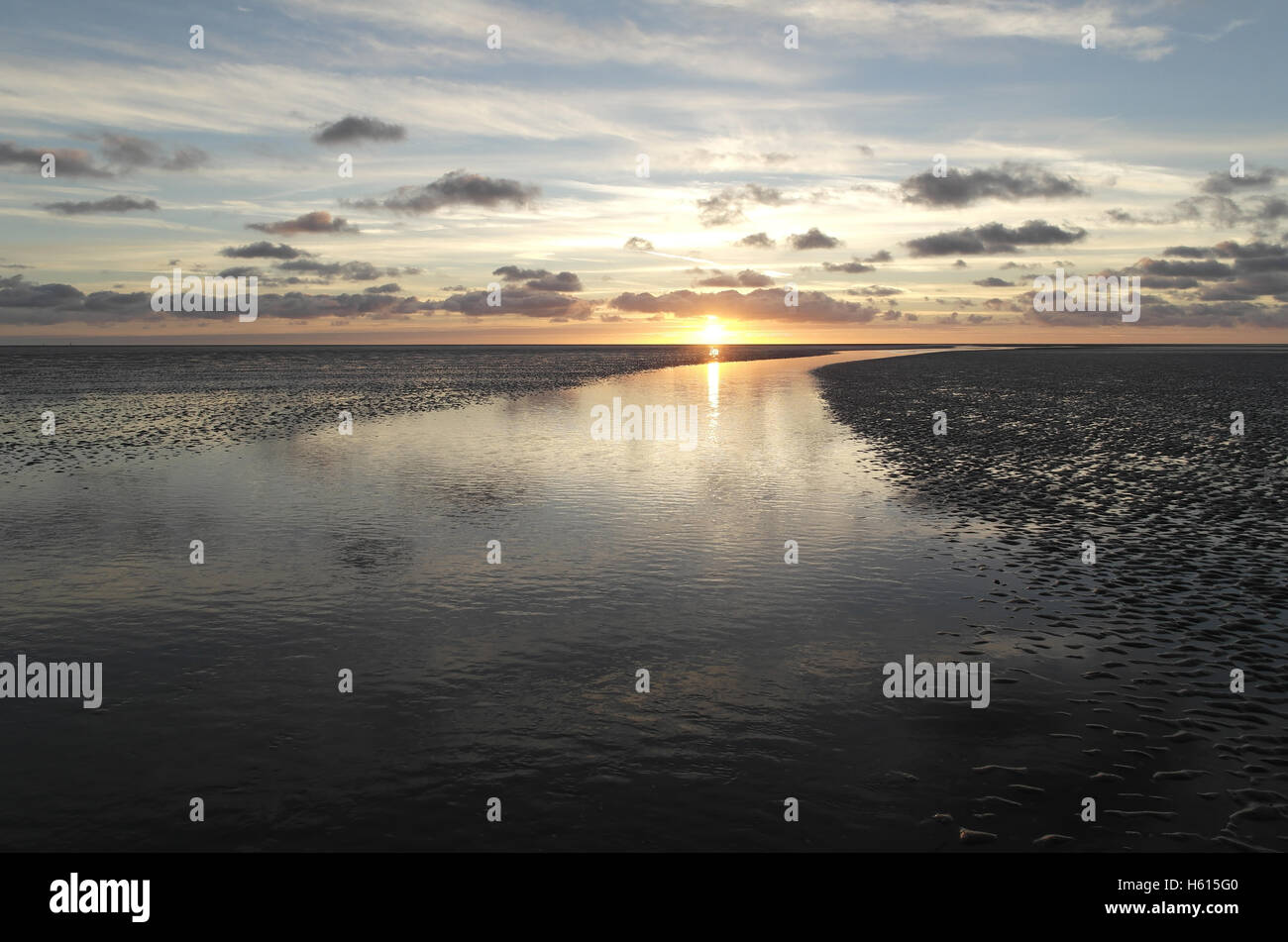 Wide shallow sea water channel foreground extending narrowing centre ...