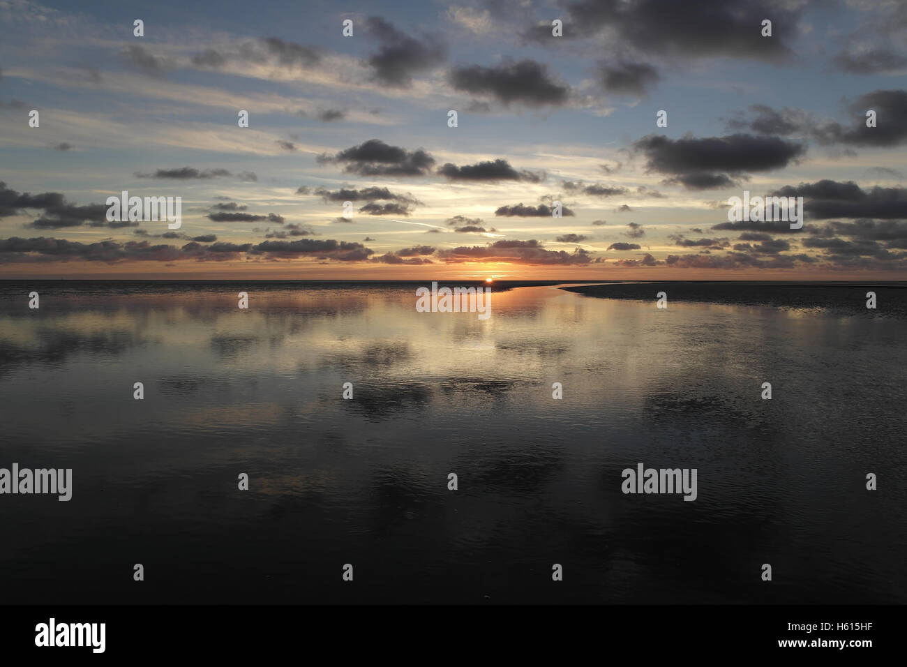 Many grey stratocumulus clouds reflecting sea water channel crossing ...